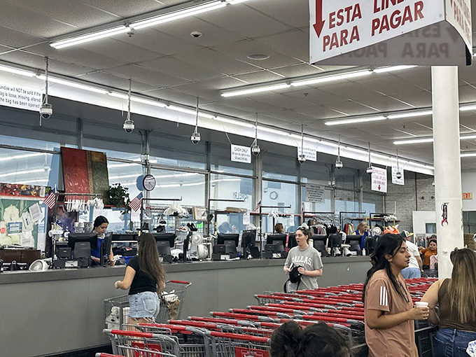 The checkout area buzzes with anticipation as shoppers line up with carts full of discoveries, each person clutching their unique finds like lottery winners.