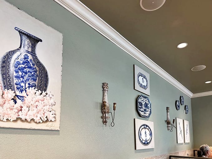 Delicate blue and white porcelain decor adorns mint-green walls, creating an atmosphere that's equal parts sophisticated Southern parlor and comfort food sanctuary.