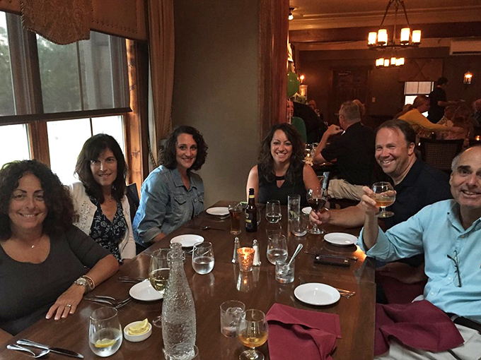 Happy faces around the table tell you everything you need to know about what just arrived from the kitchen.