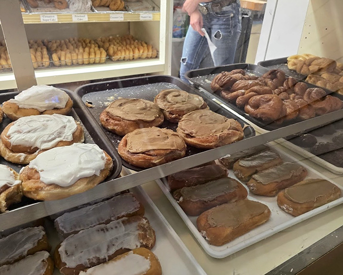 The display case reveals the behind-the-scenes magic&mdash;trays of freshly iced donuts waiting to fulfill their destiny as breakfast champions.
