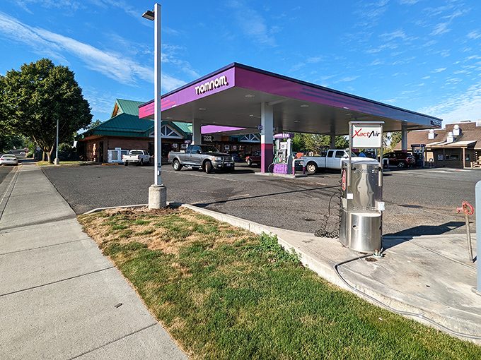 Downtown stretches out like a friendly handshake, with that purple gas station adding unexpected whimsy.