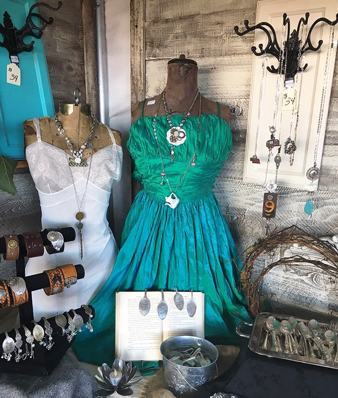 Vintage mannequins showcase upcycled jewelry made from silverware and buttons, proving that yesterday's utensils make today's statement pieces.