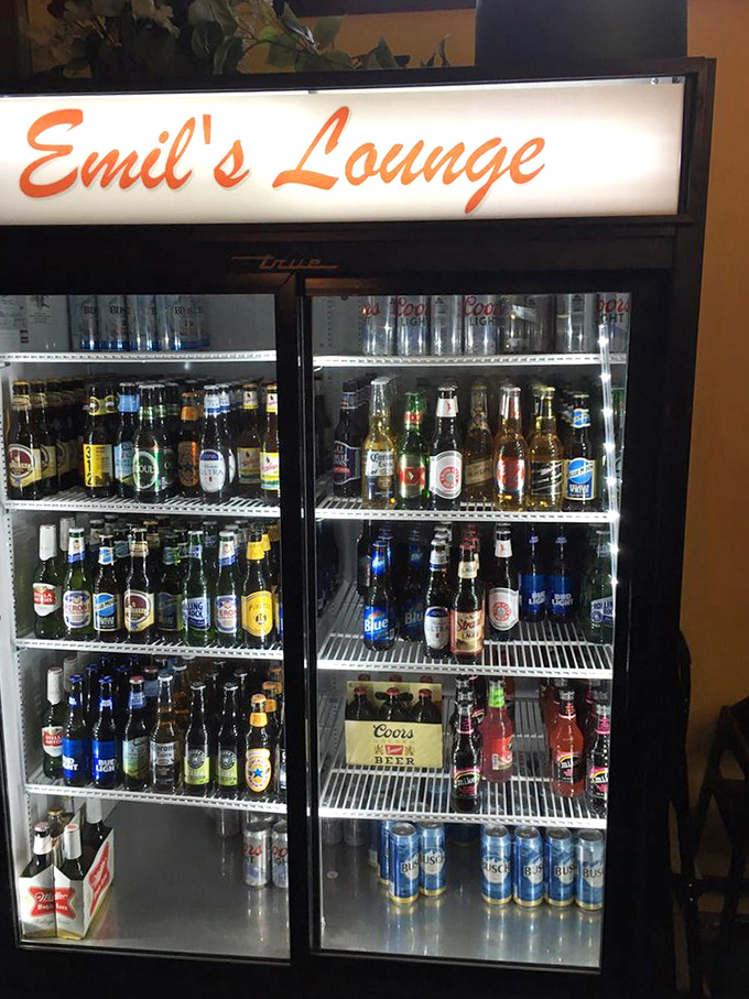 The beer cooler at Emil's &ndash; a democratic display where craft brews and blue-collar classics share shelf space in perfect harmony.
