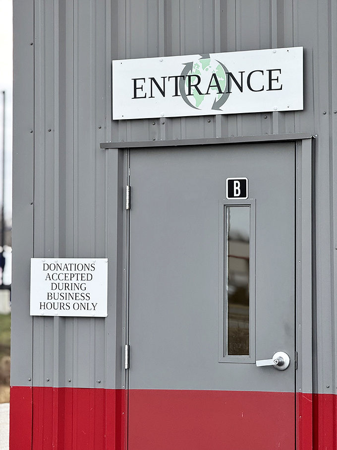 The entrance door: where ordinary shoppers enter and savvy treasure hunters emerge, donations accepted during business hours only.