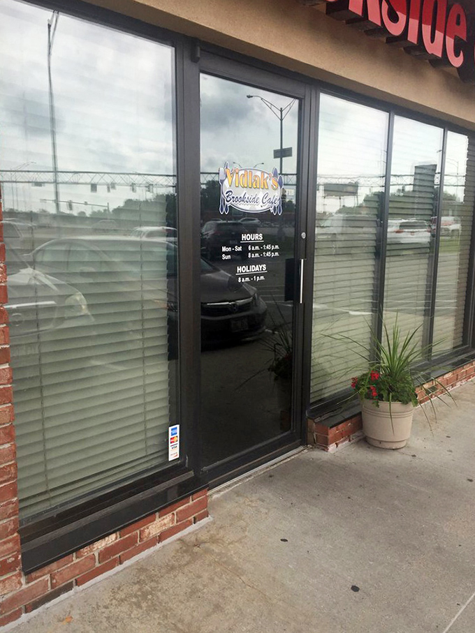 The entrance to breakfast paradise comes with clear instructions: hours posted, expectations set, and a potted plant welcoming you in. 