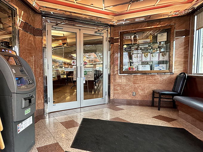 The entrance vestibule, with its marble touches and ATM, bridges the gap between vintage charm and modern convenience.