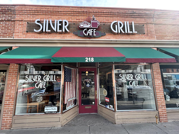 The entrance beckons with patriotic flair and the promise of comfort food that transcends trends. This doorway has welcomed generations of hungry Coloradans.