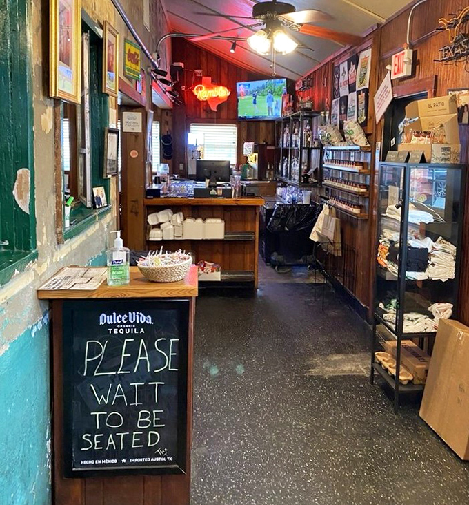The entryway says it all: "Please Wait To Be Seated" is less a command and more a promise that something wonderful awaits beyond that wooden counter.