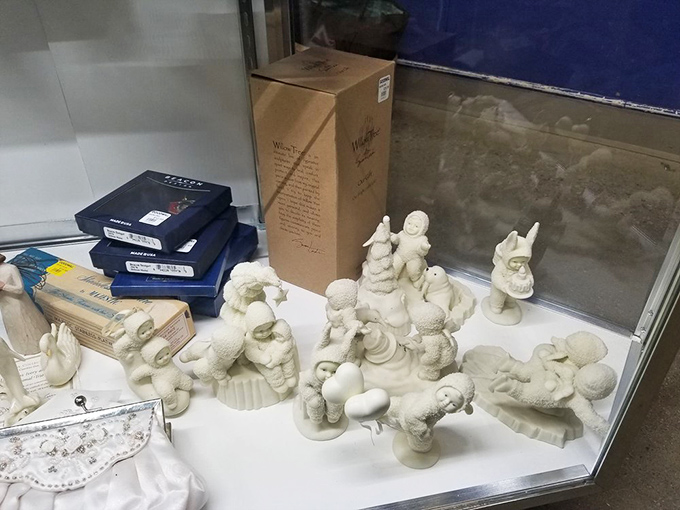 Porcelain figurines frozen in eternal optimism. Someone's former collection awaits a new shelf to call home—perhaps yours?