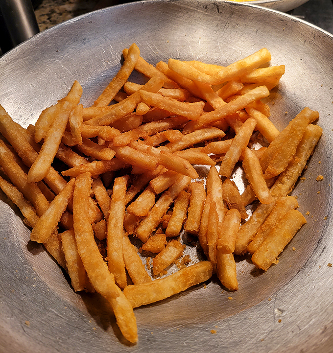 Golden fries that achieve that perfect crisp-outside, fluffy-inside balance&mdash;simple perfection in a metal serving bowl that never stays full for long.