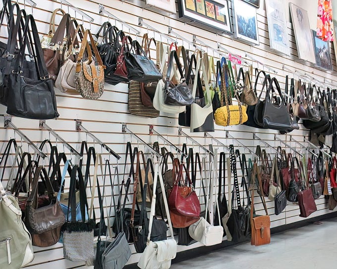 The handbag wall displays more variety than an airport's international terminal. Each purse represents a different style personality waiting to be adopted.