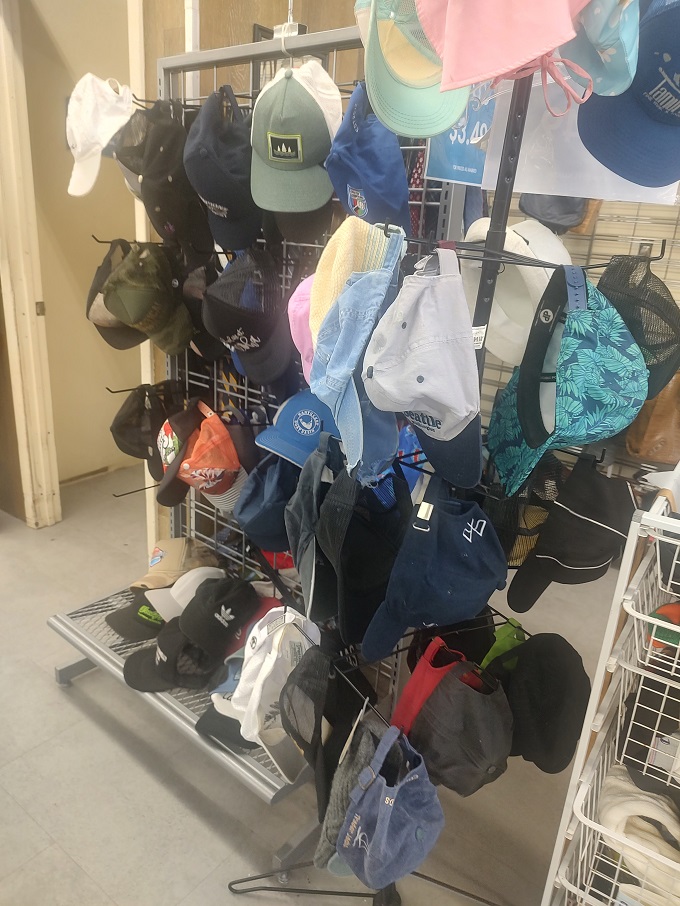 Hat rack heaven! From baseball caps to beach hats, headwear for every island adventure awaits. That blue one practically screams "boat day."