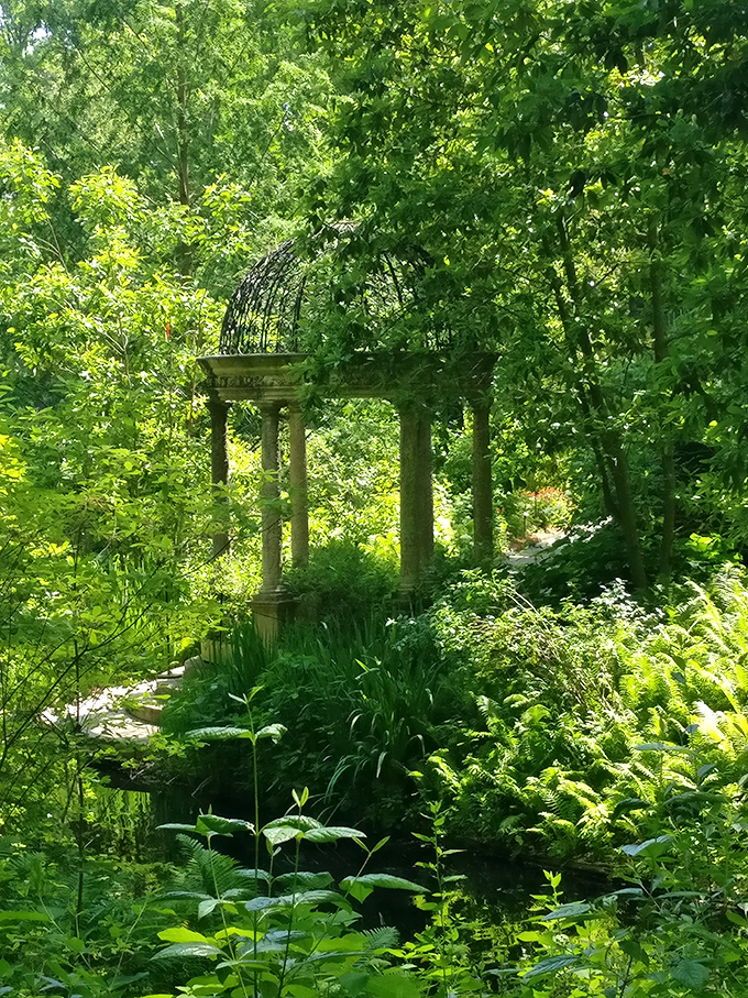 Classical columns create a secret garden temple where you half expect to find ancient gods taking a coffee break from Olympus.