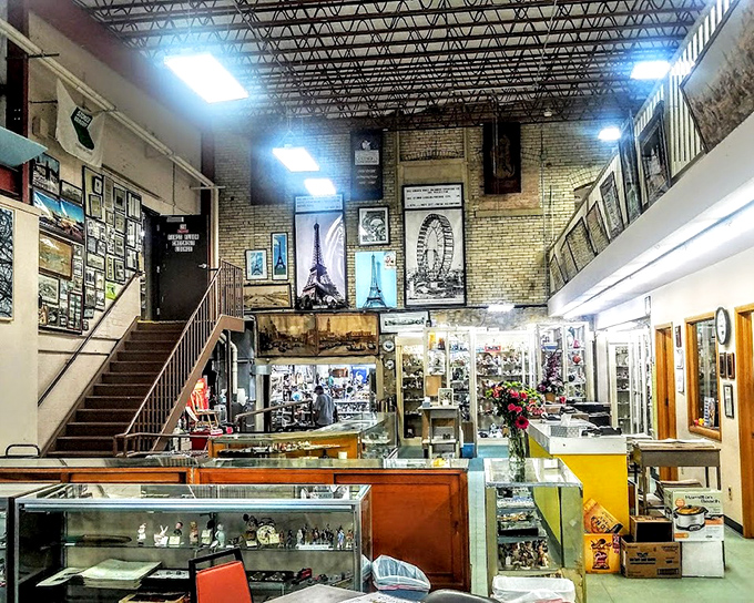The grand entrance hall feels like a time portal, where Eiffel Tower prints and display cases guard treasures from bygone eras.