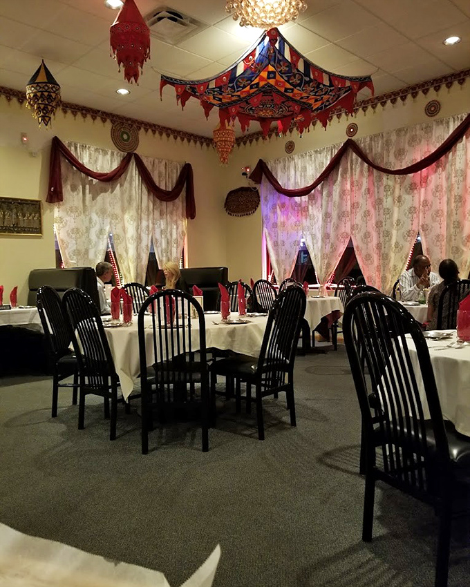 Colorful fabric canopies hover above diners like festive clouds, creating an atmosphere that enhances every bite with a touch of magic.