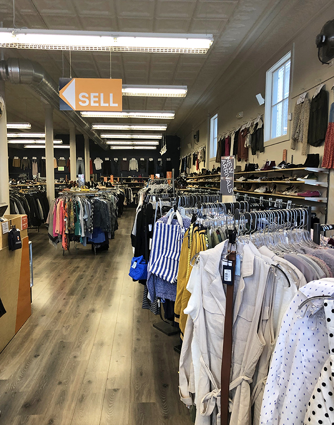 The "SELL" sign says it all&mdash;this fashion ecosystem thrives on the circular economy of style. One person's castoff, another's treasure.