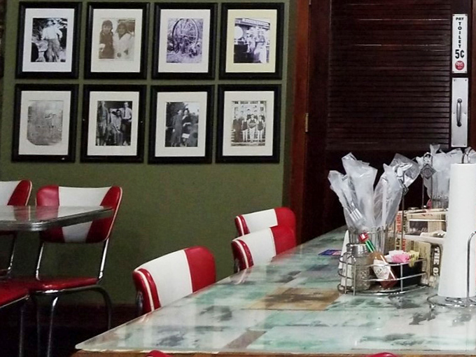 Black and white photos line the walls like a visual history book, watching over diners who create their own memories beneath vintage ceiling fans.