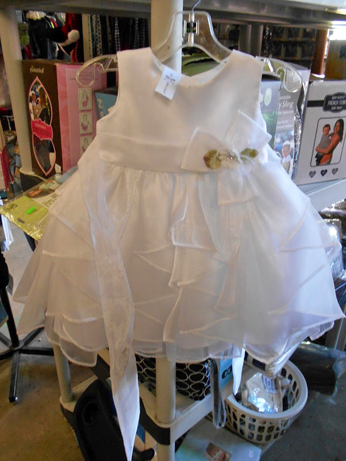 A pristine white dress awaits its big moment. Someone's flower girl is about to make the cutest entrance since kittens discovered YouTube.