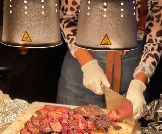 Skilled hands transforming smoked meat into edible art. That knife isn't just cutting brisket&mdash;it's conducting a symphony of flavor.