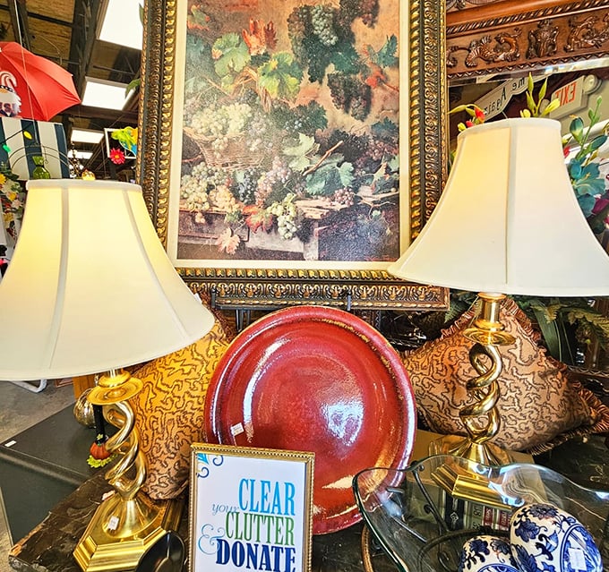 Elegant lamps flanking artwork that once graced someone's formal dining room. The "Clear Your Clutter" sign offers permission to bring them home.