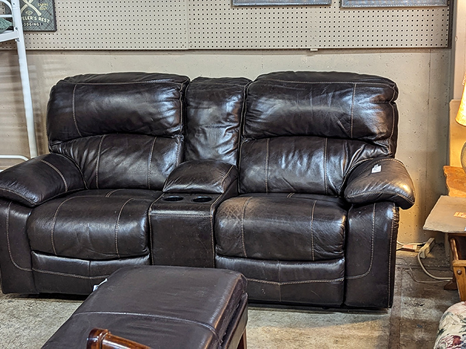 This leather loveseat has character lines earned from years of movie nights. Just add popcorn and someone worth sharing the center console.