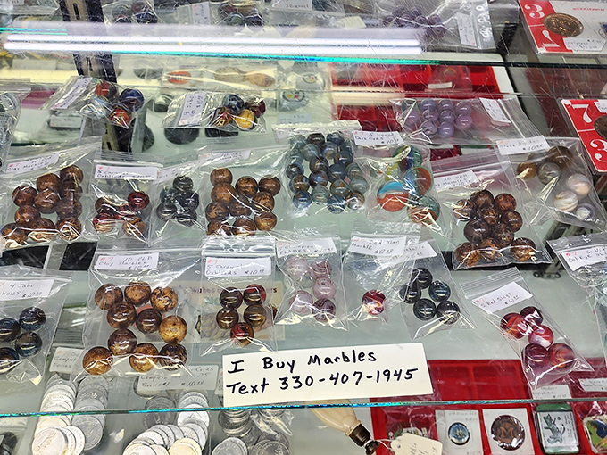 "I buy marbles" proclaims the sign, and what a collection! These glass spheres of swirling color were the original fidget spinners of generations past.