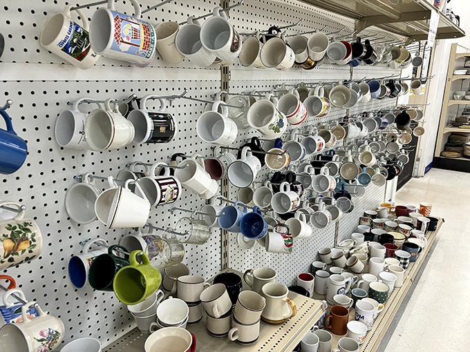 Mug mountain: where coffee vessels multiply like rabbits. That "World's Best Grandpa" cup is about to join a new family tree.