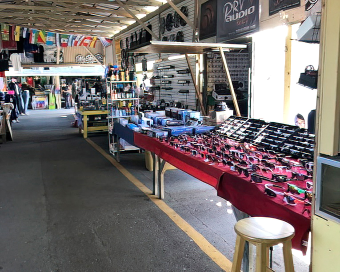 Sunglasses galore! This red-clothed table offers protection from Florida's famous sunshine with styles ranging from practical to "who would wear that?"