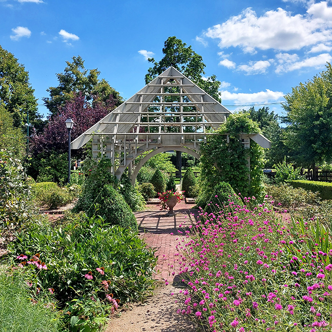 Garden architecture that invites daydreaming. This wooden pyramid frames the path ahead like a doorway to botanical adventures.
