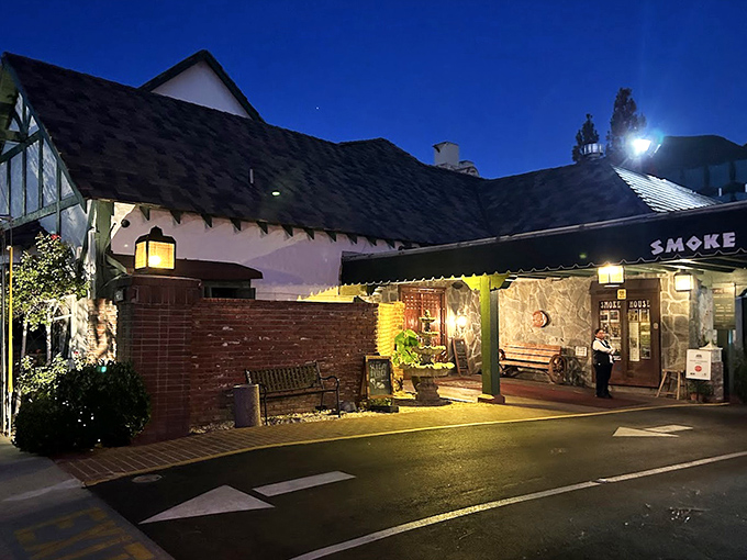 As evening falls, the exterior transforms into a warm, glowing haven that beckons passersby with promises of cocktails and conversation.