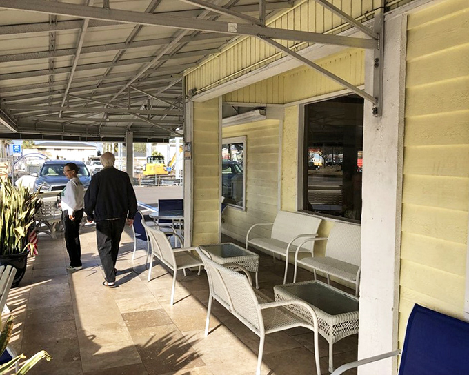 The covered porch offers a gentle transition between Florida sunshine and breakfast bliss, where waiting feels less like waiting and more like anticipation.