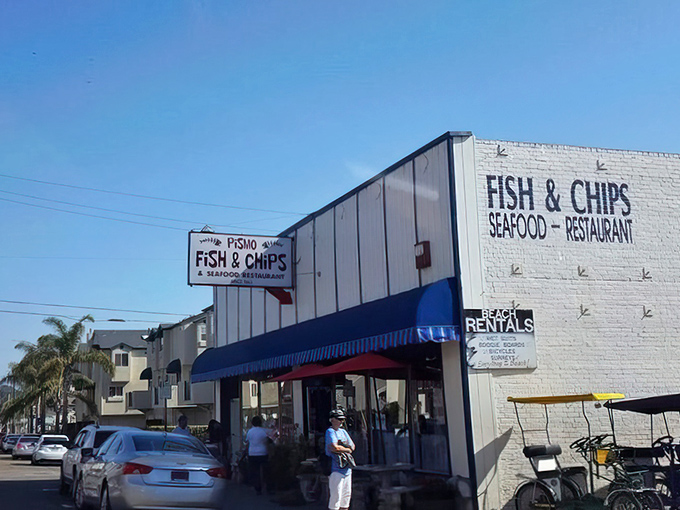 The white building with blue awning stands like a lighthouse for hungry travelers navigating the California coast.