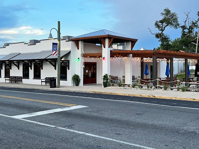 As dusk settles, the patio transforms into a coastal oasis. The kind of place where one drink easily turns into "should we just stay for dinner?"