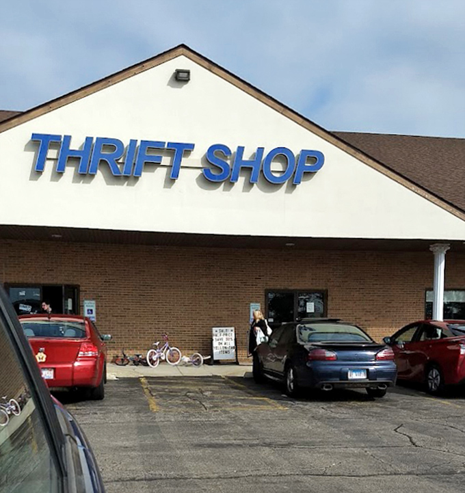 The parking lot view: where cars gather like hopeful miners during a gold rush, their drivers inside hunting for treasures at Illinois' bargain headquarters.