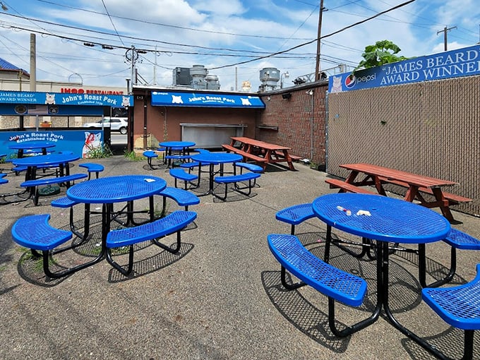 The outdoor dining area&mdash;where blue tables match the iconic awning and conversations revolve around one question: "How good is this sandwich?"