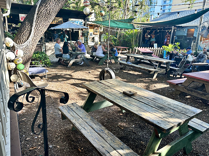 Picnic tables under shade trees &ndash; where conversations flow as easily as the drinks and seafood arrives at a perfect Florida pace.