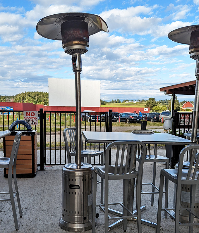 Patio heaters and high-top tables offer a civilized spot to enjoy snacks while gazing at the screen.