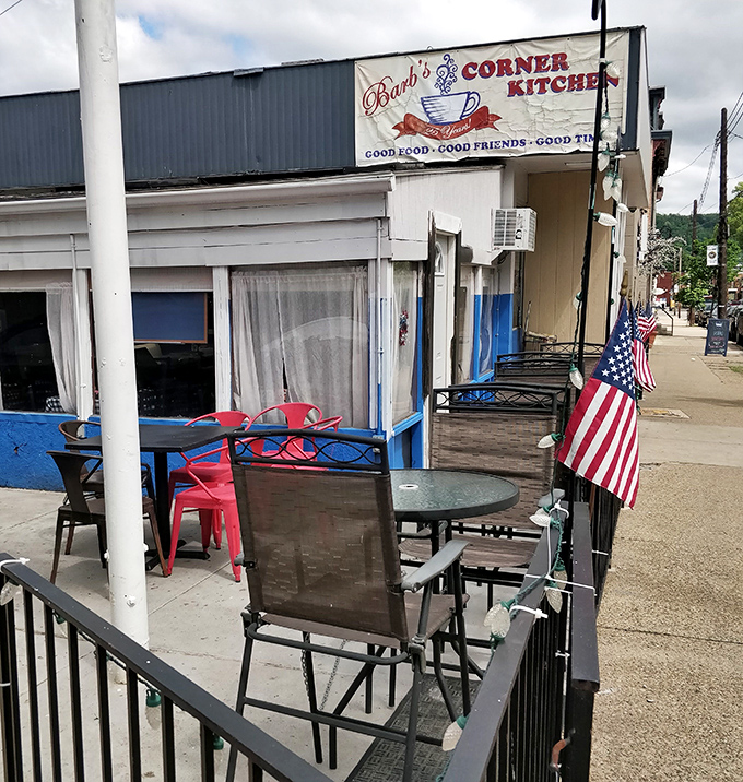 The outdoor patio where summer breakfasts taste even better. American flags flutter as gentle reminders that diners are part of something bigger than breakfast.