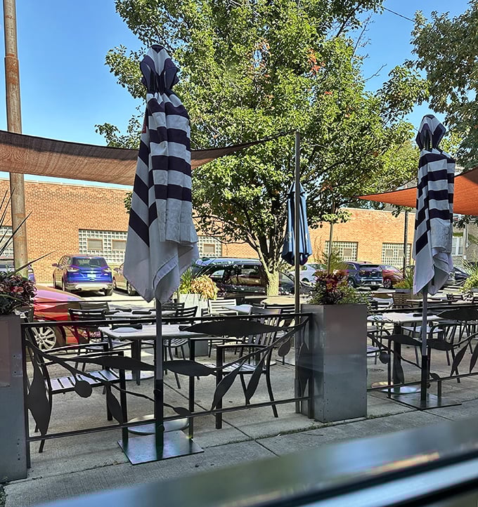 Al fresco dining, Chicago-style &ndash; striped umbrellas shield diners from summer sun while they savor slices and pretend they're on an Italian holiday.