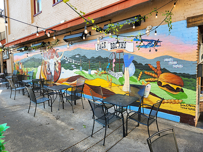 A vibrant mural transforms the outdoor patio into a storybook setting&mdash;because great burgers deserve equally great backdrops.