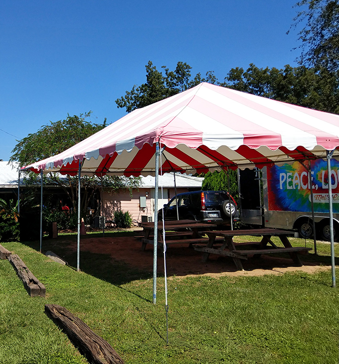Outdoor seating under cheerful striped tents adds a carnival atmosphere to your dining adventure experience.