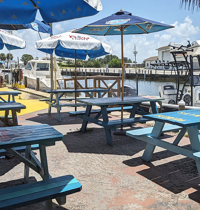 Picnic tables painted in coastal blues &ndash; Florida's version of reserved seating. The water views come complimentary with every order of grouper.