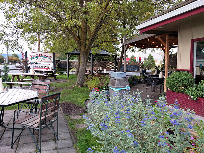 The outdoor seating area &ndash; where Oregon's natural beauty meets culinary artistry. Picnic tables under trees create the perfect stage for burger bliss.