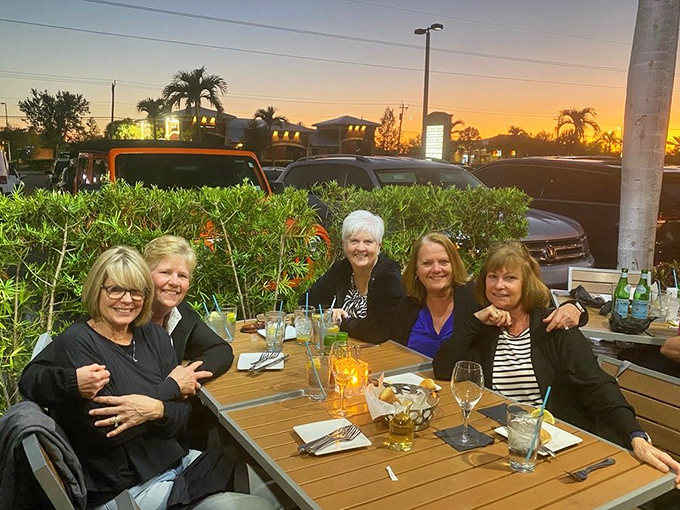 Sunset dining on the patio proves that seafood tastes even better with a Florida sky backdrop. These ladies aren't just having dinner&mdash;they're creating memories seasoned with ocean breezes.