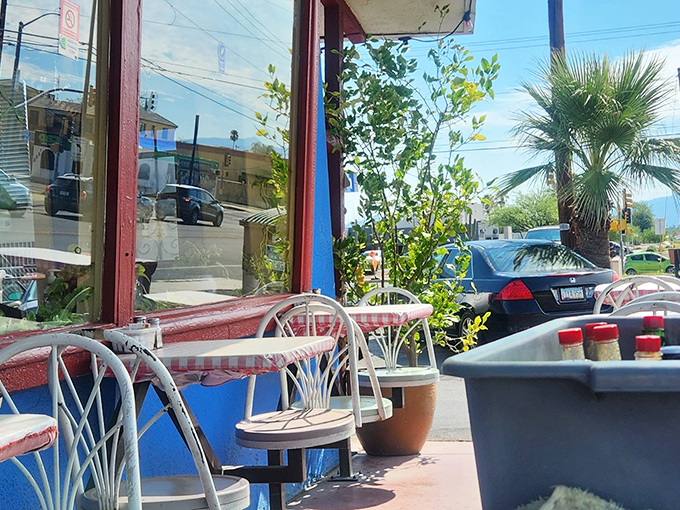 Patio seating that captures Tucson's essence&mdash;casual, sun-drenched, and perfectly imperfect. Those blue walls aren't just paint; they're Frank's signature on the neighborhood.