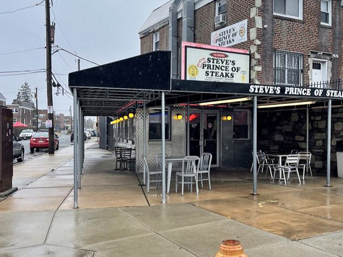 Rain or shine, the outdoor seating beckons. Even in dreary weather, the yellow lights create an oasis for cheesesteak devotees.
