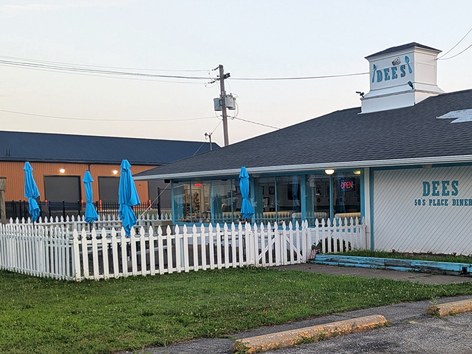 The outdoor seating area with its white picket fence adds even more small-town charm to this gem.