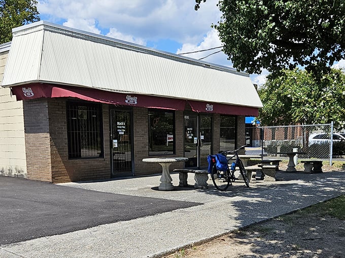 The outdoor setting offers a humble concrete patio with stone tables—no farm-to-table pretension, just honest-to-goodness eating space under South Carolina skies.