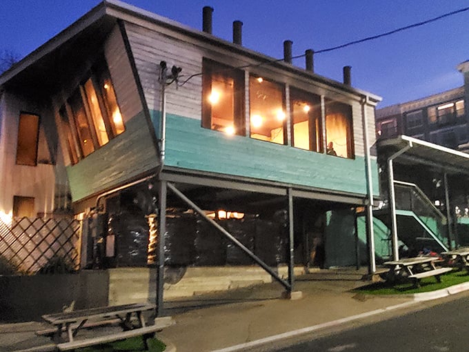 As evening falls, the turquoise glow of Franklin Barbecue beckons like a lighthouse guiding hungry souls to safe harbor.