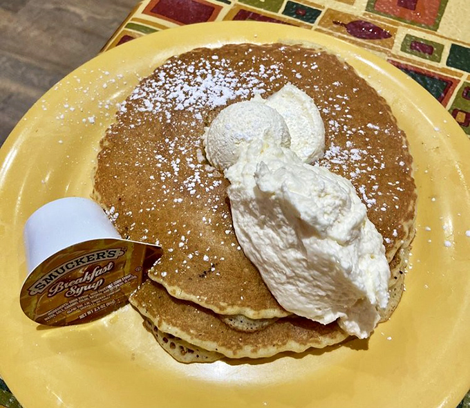 Fluffy pancakes dusted with powdered sugar and topped with whipped cream&mdash;breakfast comfort food that hugs you from the inside out.